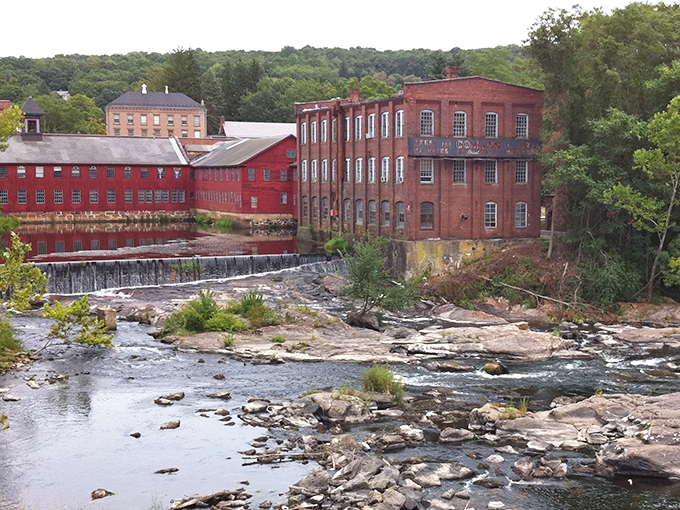 The old Collins Axe Factory stands sentinel over the Farmington River, a red-brick reminder that American craftsmanship once meant something more than "assembled elsewhere."