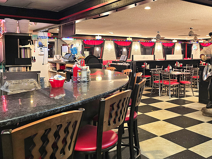 Classic Americana comes alive inside with that perfect diner trifecta: checkered floors, red vinyl booths, and counter seating where breakfast dreams come true.