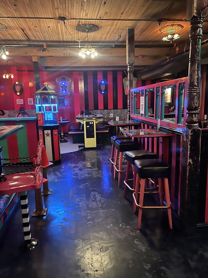 Step inside and you're transported to a circus fever dream where red and black stripes, vintage fixtures, and carnival aesthetics collide in delightful sensory overload.