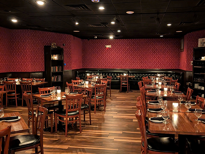 Step inside and the red damask wallpaper, dark wood tables, and leather booths transport you to a Prohibition-era hideaway where Sinatra would feel right at home.