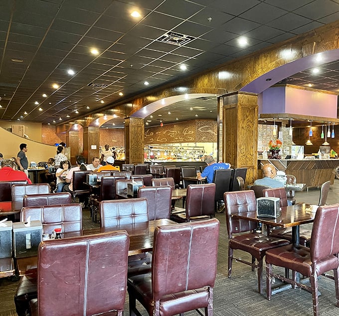 Comfortable leather chairs await as diners strategize their buffet battle plan beneath warm lighting and wood-accented columns.