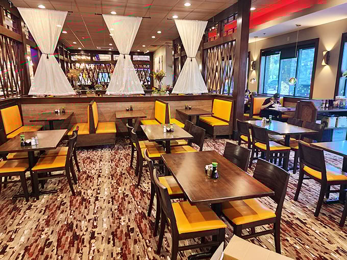 Bright yellow chairs pop against wooden tables, creating a cheerful dining space where the only serious business is deciding which buffet station to hit first.