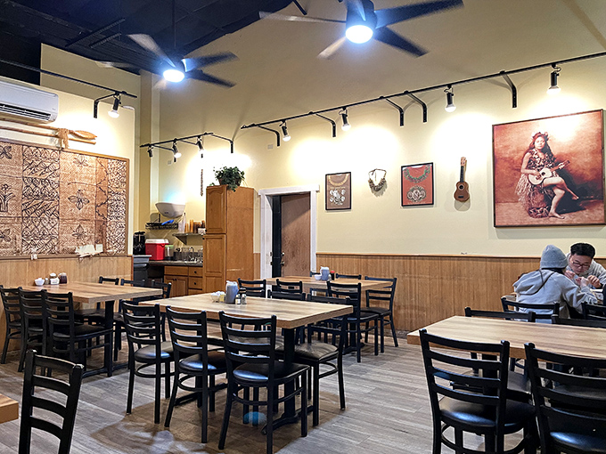 Simple wooden tables and Hawaiian artwork create an unpretentious atmosphere where the food, not the decor, takes center stage.