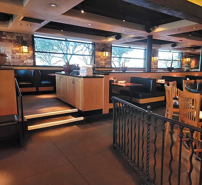 Multi-level dining with stone walls and warm lighting creates intimate spaces that feel miles away from ordinary.