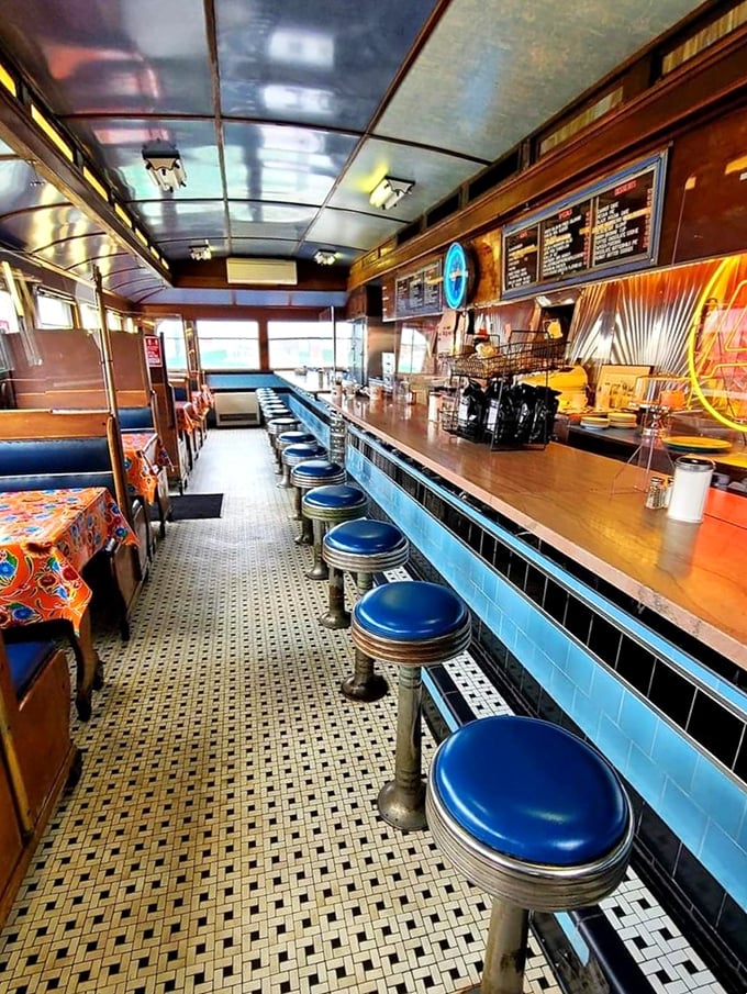 The diner's narrow interior is a masterclass in American design efficiency&mdash;blue vinyl stools, polished counter, and the promise of conversations that matter.