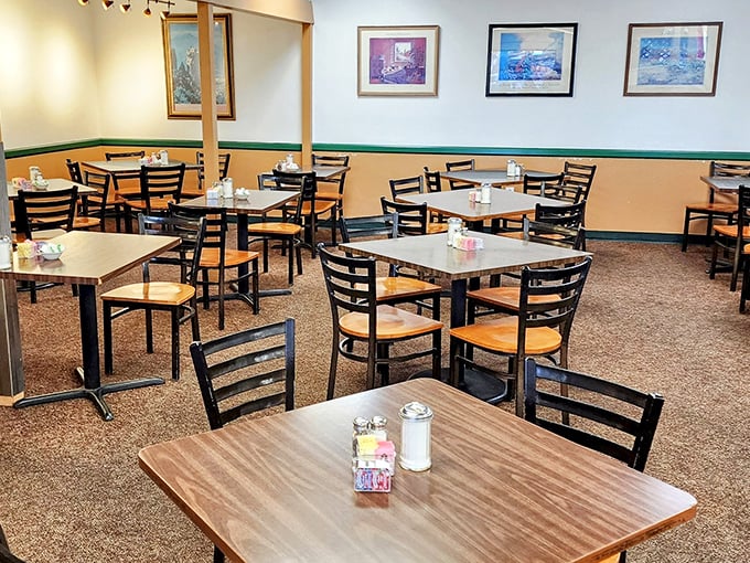 Simple tables, comfortable chairs, and framed artwork create that perfect "second home" feeling where conversations flow as freely as the coffee.