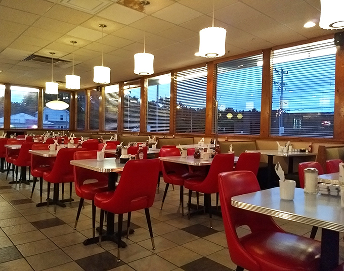 Those vibrant red chairs aren't just seating; they're front-row tickets to Delaware's most authentic culinary theater.