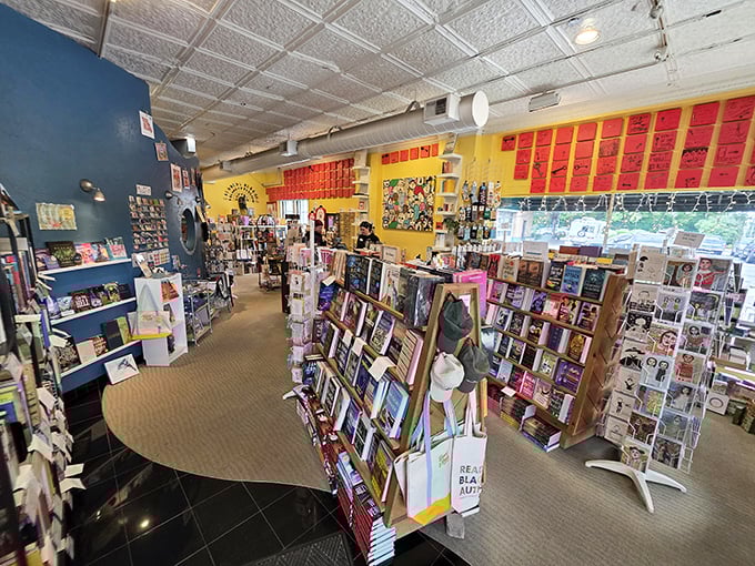 Vibrant yellow walls and carefully curated displays create a literary labyrinth where getting lost is half the fun. Bookstore or treasure hunt? Both.