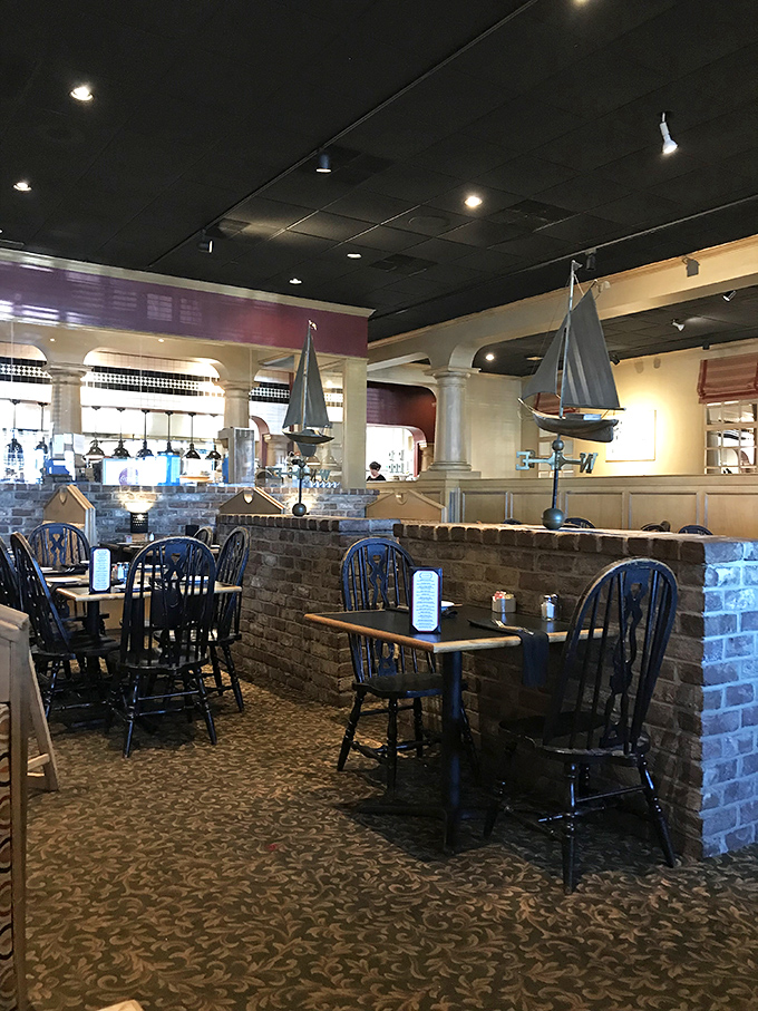Nautical touches meet cozy comfort in Tucker's dining room, where brick half-walls and model sailboats create an atmosphere that says "relax, you're about to eat really well."