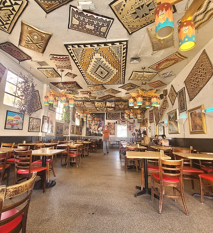 Navajo rugs adorn every inch of ceiling space like a Southwestern art gallery where the admission fee is simply ordering the green chile stew.