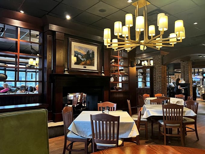 Elegant chandeliers cast a golden glow over white tablecloths and dark wood &ndash; the perfect lighting to make both your date and your steak look magnificent.