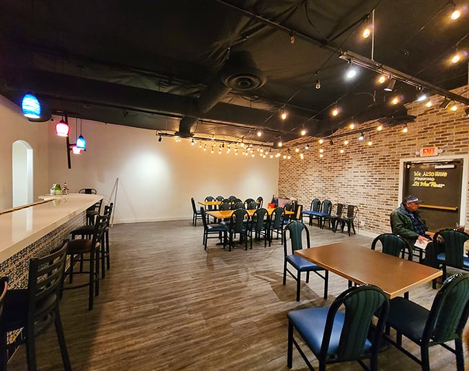 The dining room strikes that perfect balance between cozy and spacious, with exposed brick walls and string lights creating an instant "welcome home" vibe.