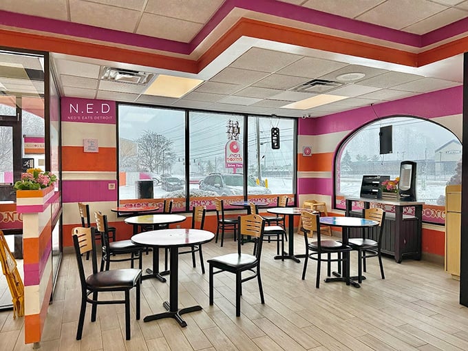 Inside, the pink and orange stripes continue, creating a cheerful atmosphere that makes waiting for your donut selection feel like being inside a happy daydream.