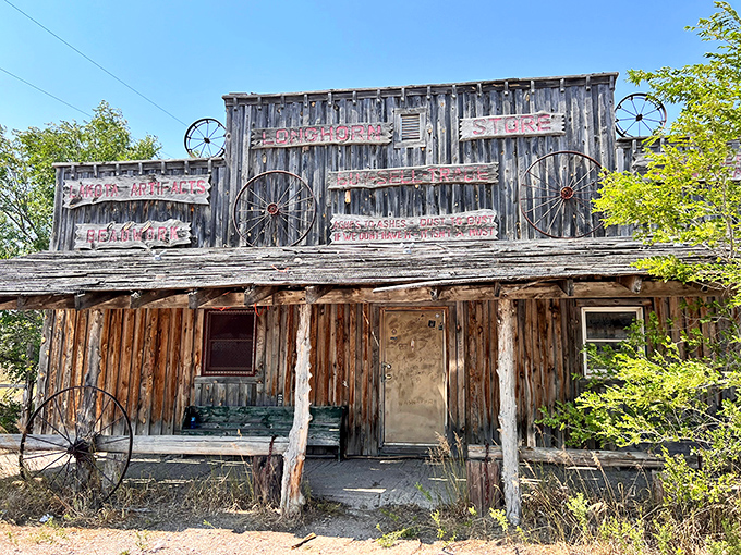 The Longhorn Store stands as a rustic sentinel of commerce past, its wagon wheel decorations and weathered signage telling stories no history book could capture.