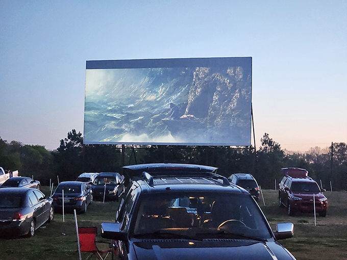 That magical moment when the first frame hits the screen and everyone settles in. Modern technology meets nostalgic tradition at dusk.