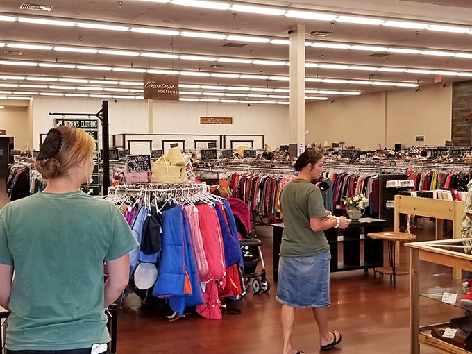 Shoppers navigate the colorful clothing aisles with the focused determination of archaeologists, each rack a potential site for the next great discovery.