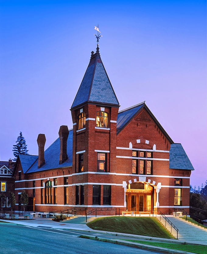 The Town Hall Theater glows at dusk like a brick-and-mortar time machine, its warm lights promising cultural delights that cities ten times Middlebury's size would envy.
