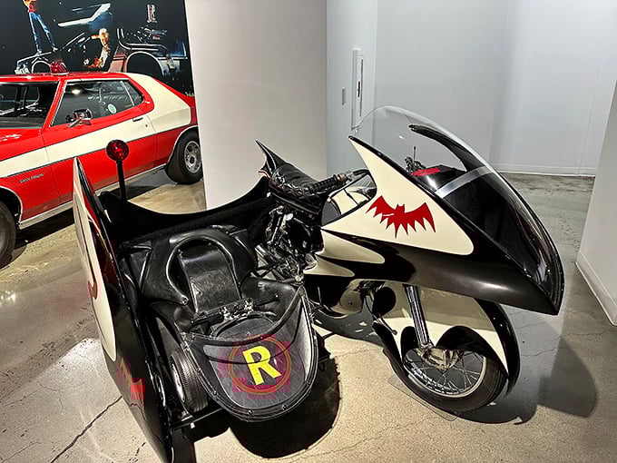 Holy transportation, Batman! The iconic Batcycle sits ready for action, complete with Robin's sidecar &ndash; proving even superheroes need stylish wheels for fighting crime.