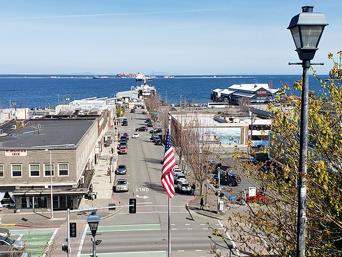 First Street stretches toward the Strait like an invitation, the American flag standing sentinel over a downtown that refuses to surrender to chain-store conformity.