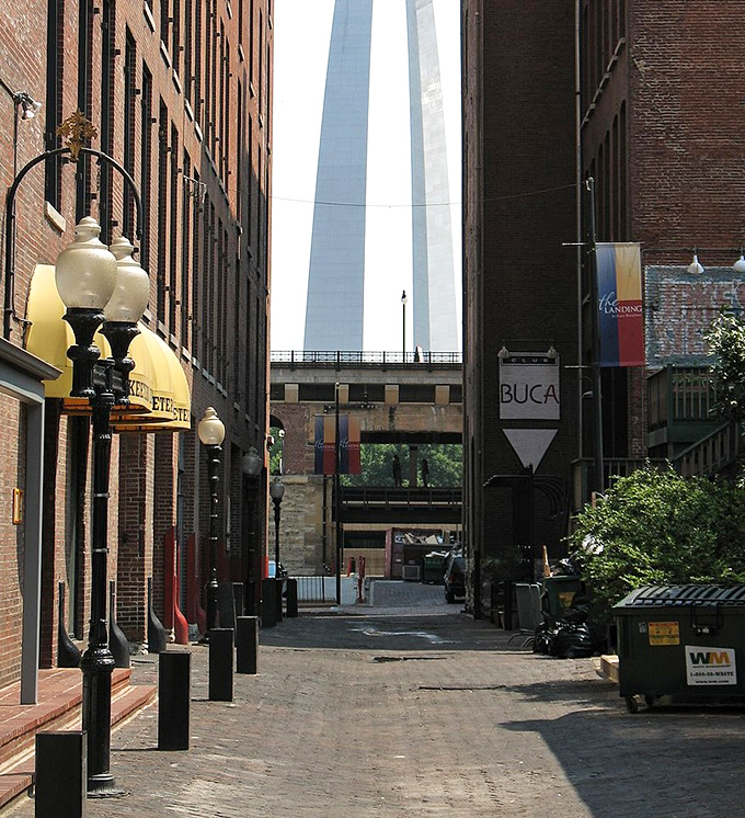 A charming brick alleyway where the Gateway Arch plays peekaboo between historic buildings&mdash;the kind of urban scene that makes you want to open a detective agency just for the ambiance.