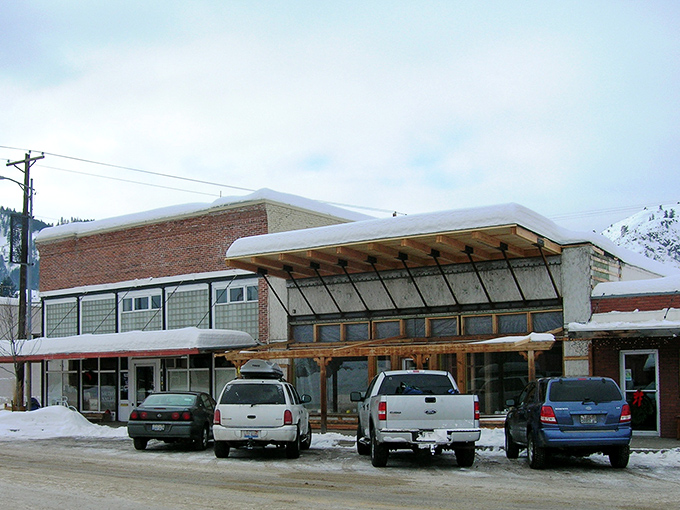 Winter transforms TwispWorks into a snow-dusted community hub where creativity thrives year-round. The architecture blends rustic charm with modern purpose.