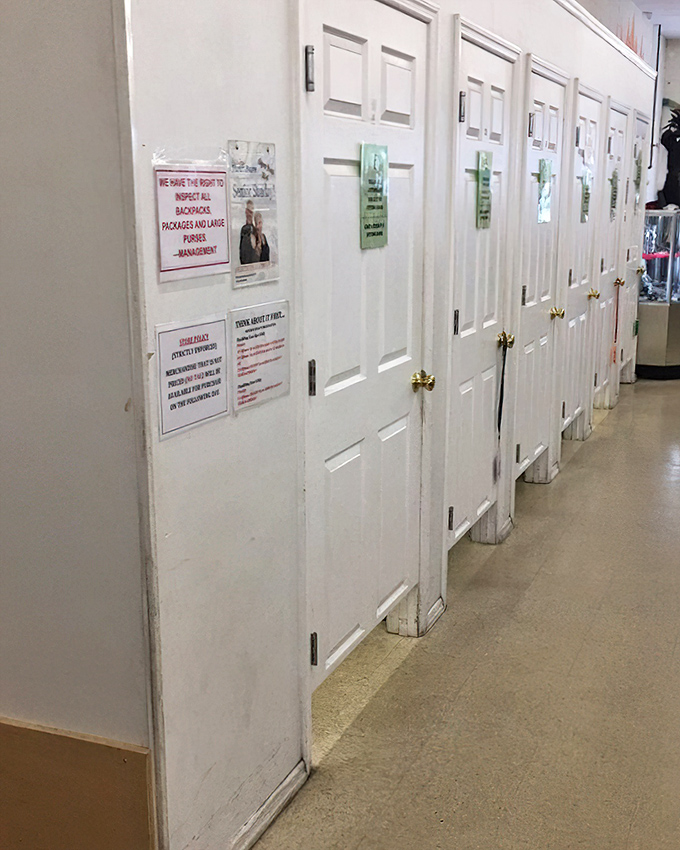 These fitting rooms have seen more fashion decisions than a Project Runway marathon. White doors guarding the moment of truth: "Does this still fit?"