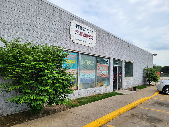 Colorful banners promise "Antiques," "Toys," and "Flea Market" treasures, while lush greenery frames this portal to the past. Your adventure begins at this doorway.