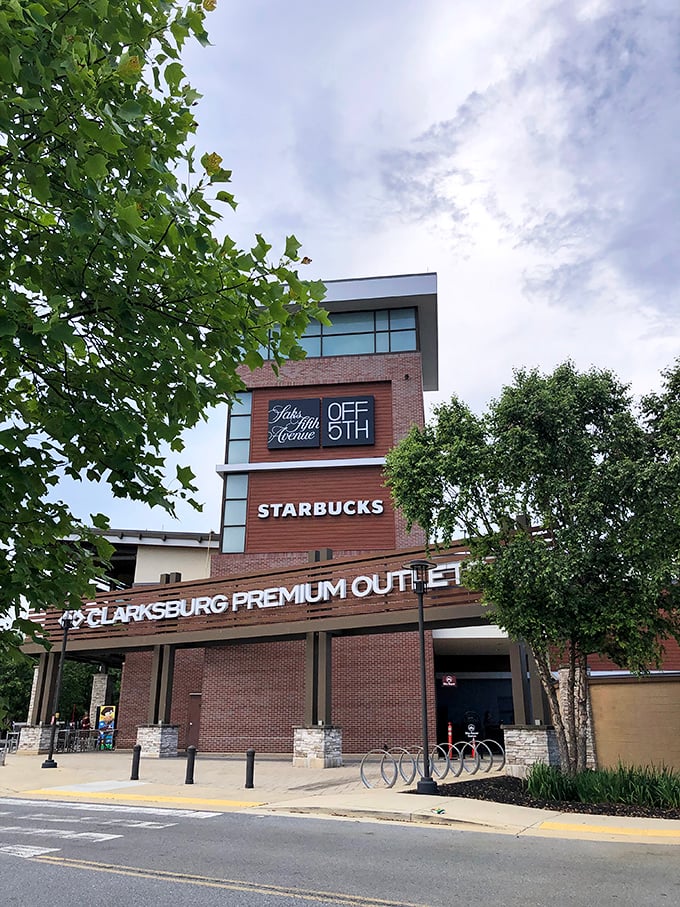 The entrance to Clarksburg Premium Outlets features Saks OFF 5TH and Starbucks &ndash; because serious shopping requires serious caffeine.