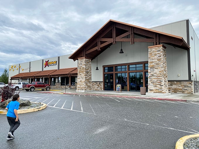 Rustic meets rush hour at this stone-and-timber entrance, where the promise of indoor thrills beckons even as Alaska's majesty looms in the background.