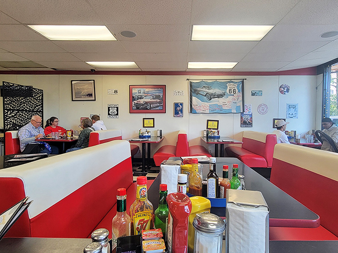 Classic red and white booths create the perfect backdrop for morning conversations, where Route 66 memorabilia meets Last Frontier hospitality.