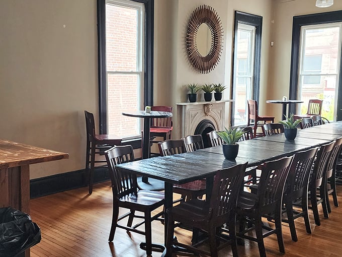 Inside, wooden floors and a sunburst mirror create the perfect balance of "fancy enough for date night" and "comfortable enough for Tuesday lunch."