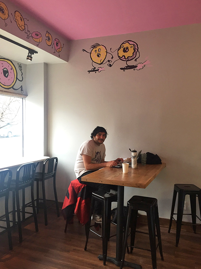 Inside, whimsical skateboarding donuts dance across pastel walls, creating an atmosphere that's equal parts playful and inviting.