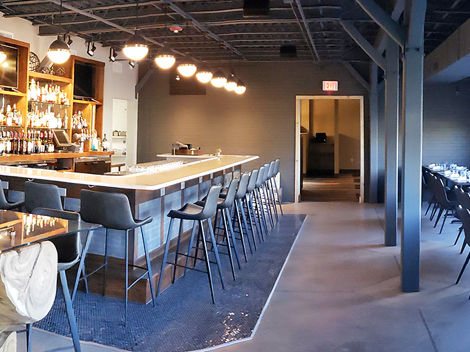 The bar at Magnolia Blue isn't just serving drinks; it's offering front-row seats to culinary theater.