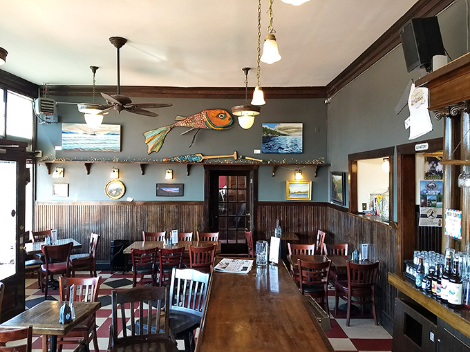 Inside, maritime charm meets rustic comfort with wooden wainscoting and that magnificent fish sculpture watching over diners like a friendly guardian of good taste.
