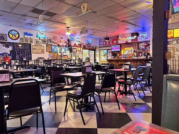 Inside, the checkerboard floor and neon-lit walls tell stories of decades past, while the aroma of fried chicken writes new memories.