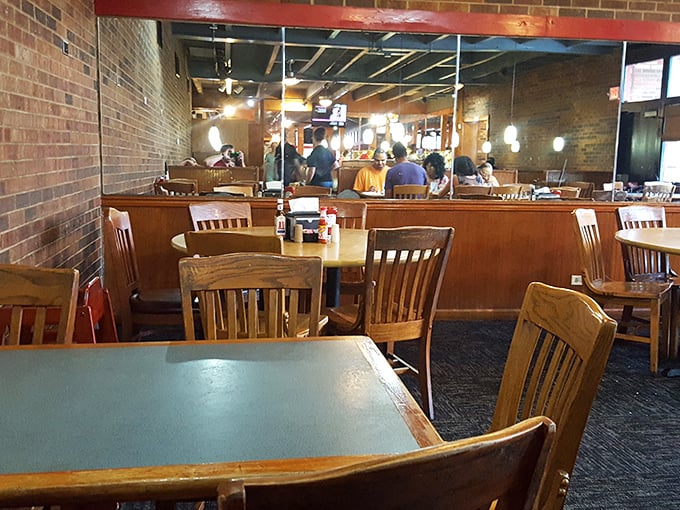 Wooden chairs, brick walls, and the distant sizzle of the grill—this dining room has hosted more happy food comas than a Thanksgiving living room.