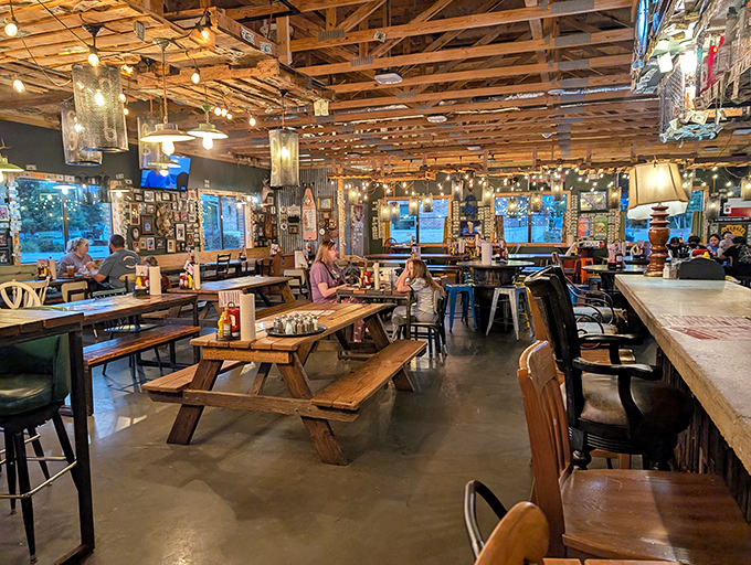 Exposed wooden beams, string lights, and picnic tables create that rare atmosphere where memories are made between bites.