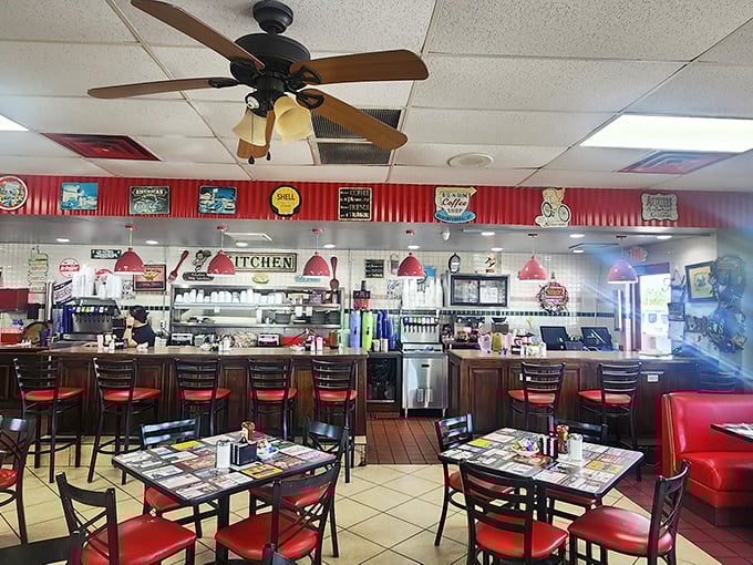 Classic diner perfection: ceiling fans lazily spinning above red vinyl booths where countless conversations have unfolded over steaming coffee cups.