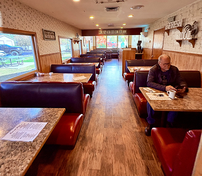 Classic diner vibes with burgundy booths and wood paneling &ndash; this isn't Instagram-bait decor, it's the real deal where conversations and coffee flow freely.