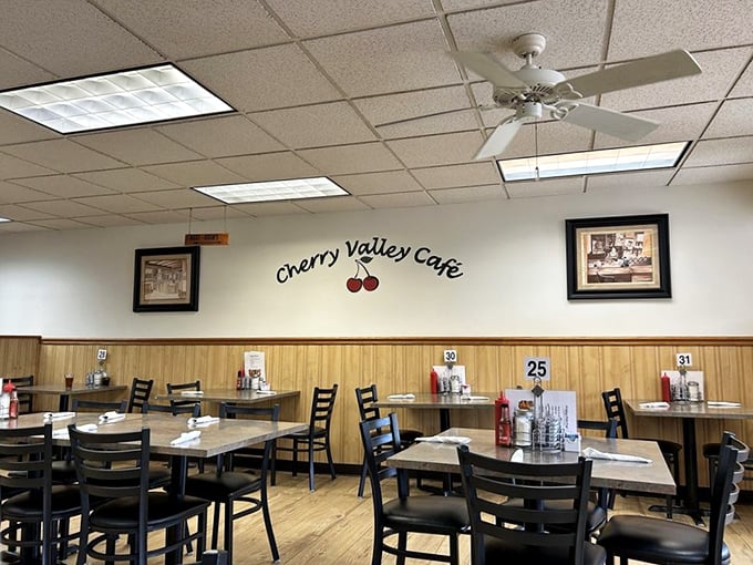 Simple wooden chairs, ceiling fans, and that cherry logo on the wall – diner perfection doesn't need to shout, it just needs to serve.