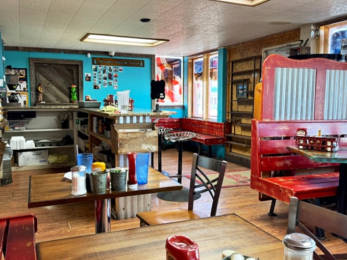 Step inside to a world where turquoise walls meet rustic wood and corrugated metal, creating the perfect backdrop for comfort food that speaks to the soul.