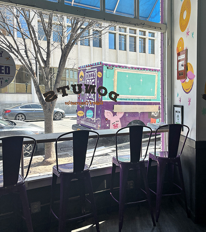 Window seats offer prime people-watching while the shop's colorful food truck stands ready to spread donut joy throughout the city.