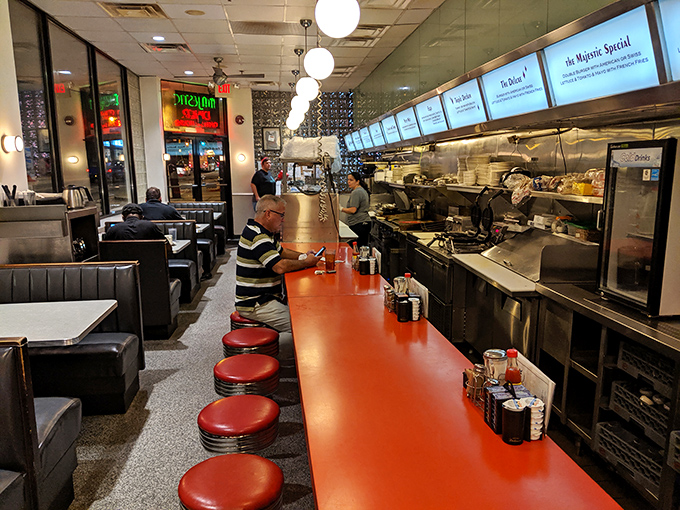 Where the counter becomes theater and every red stool tells a story of Atlanta's hungry masses.
