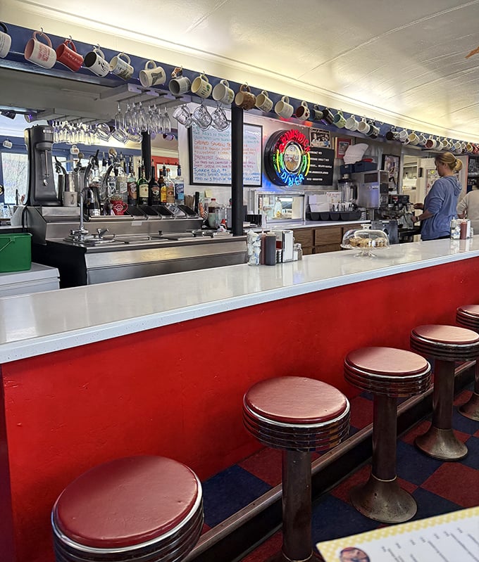 Classic counter culture at its finest—where coffee mugs hang like trophies and red vinyl stools have witnessed decades of Maine morning conversations.