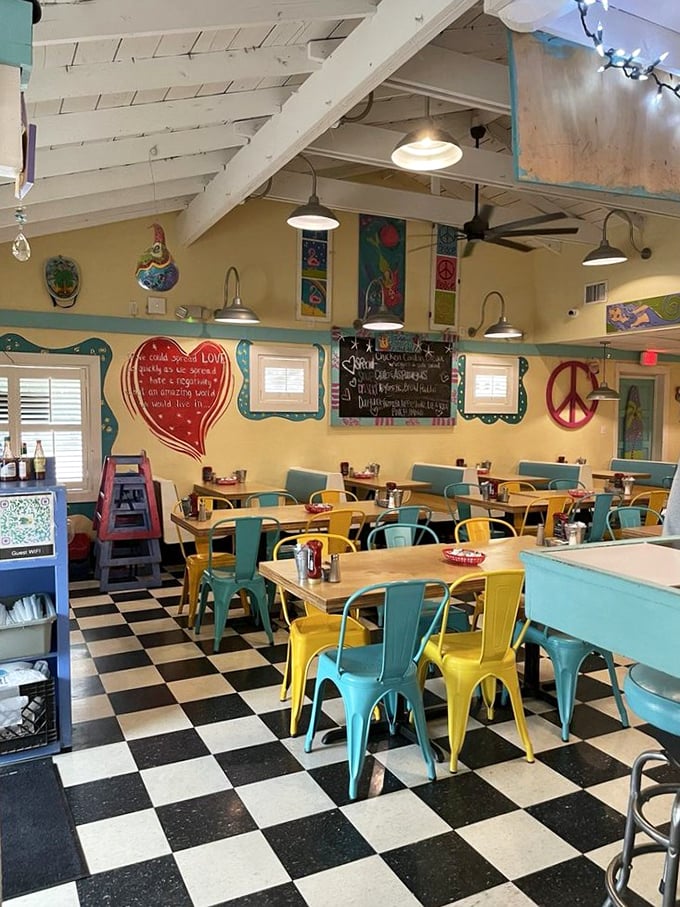 Stepping inside feels like diving into a color wheel—turquoise and yellow chairs pop against the classic checkered floor, creating joy before the first bite.