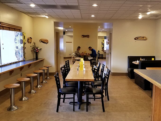 Simple wooden tables and chairs create a no-nonsense dining space where the food, not the furniture, takes center stage.