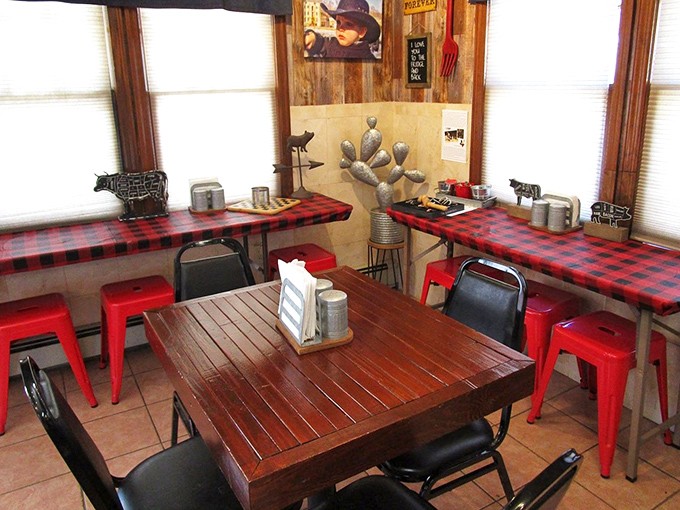 Red checkered tablecloths and metal stools create that perfect "focus-on-the-food" atmosphere where pretension goes to die and flavor reigns supreme.
