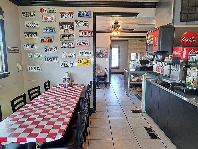 License plates from across America watch over checkered tables where barbecue dreams come deliciously true.