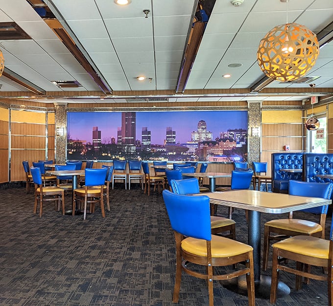 The dining room balances retro charm with urban sophistication, featuring that stunning Albany skyline mural that makes every meal feel like a special occasion.