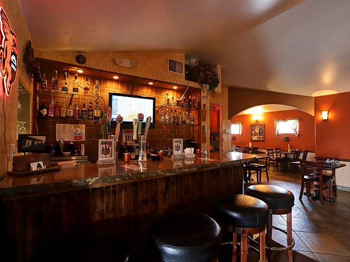 The warm wooden bar invites solo diners to perch and ponder life's great question: one more slice?